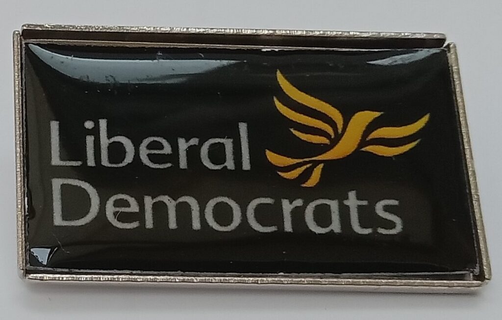 Badge Domed Black Background Gold Bird and White Print | Lib Dem Image